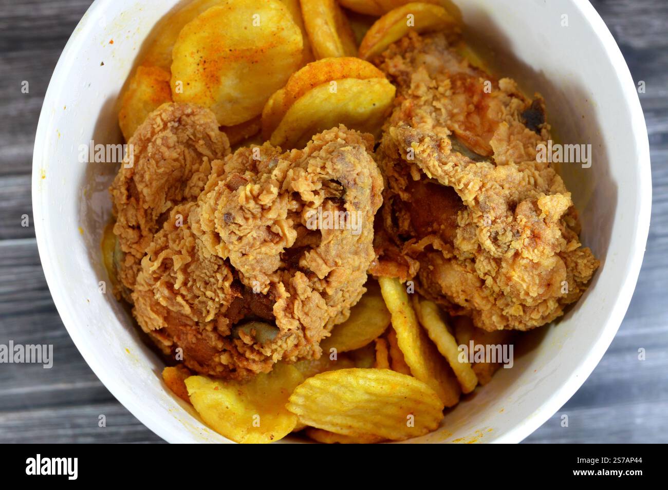 Broasted chicken meal with fried potato chips, a broast chicken pieces ...