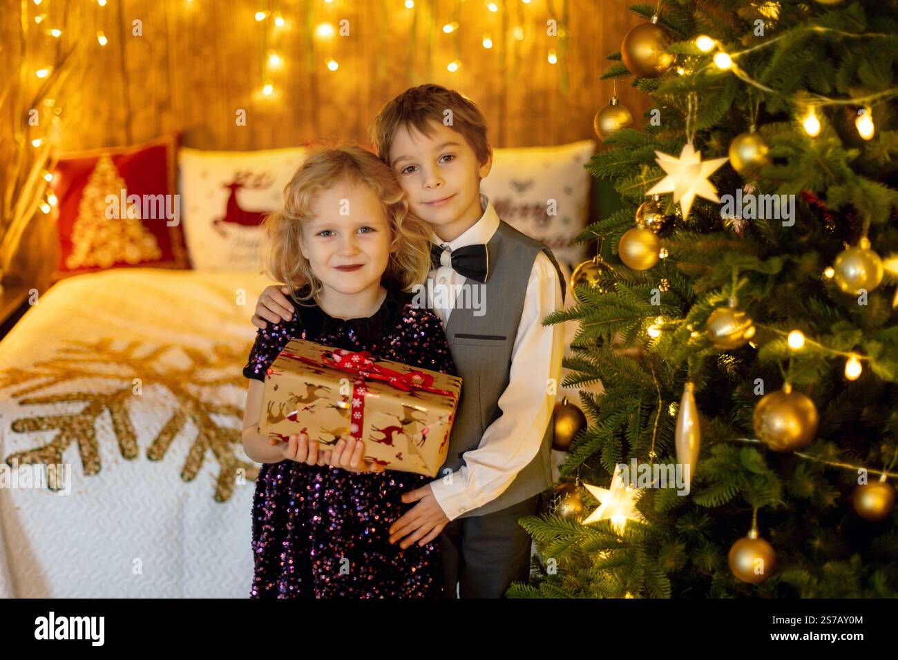 Sweet blond children, siblings, boy and girl, dressed smart casual in a ...