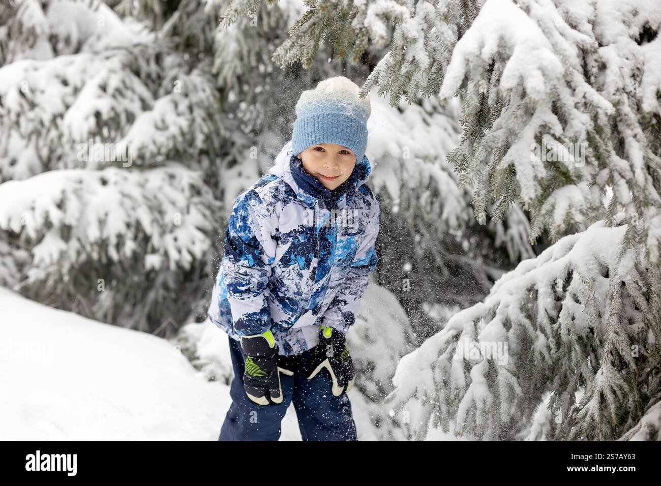 Sweet happy children, brothers, playing in deep snow in forest, frosted ...