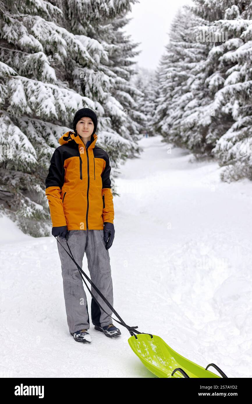 Sweet happy children, brothers, playing in deep snow in forest, frosted ...