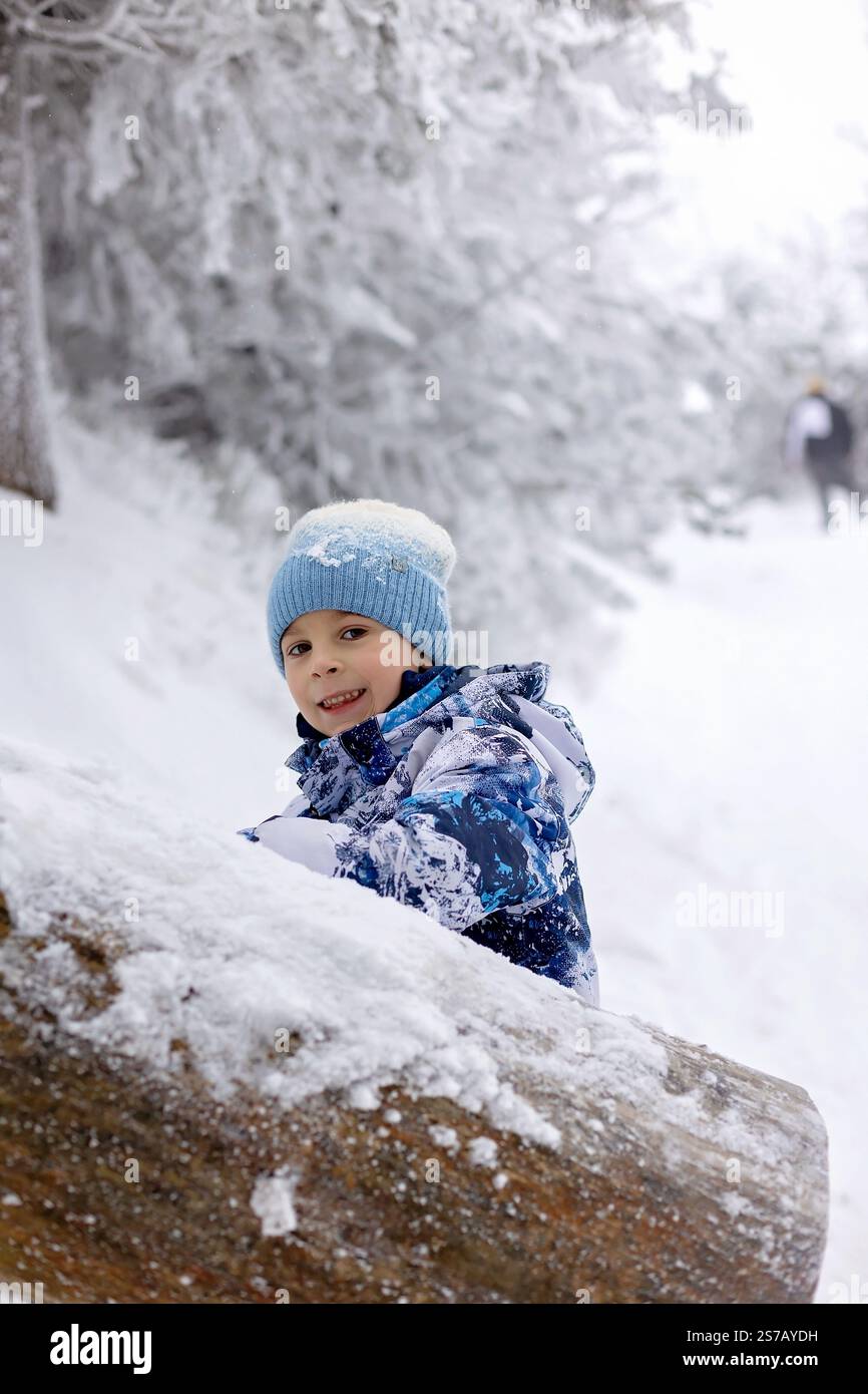 Sweet happy children, brothers, playing in deep snow in forest, frosted ...