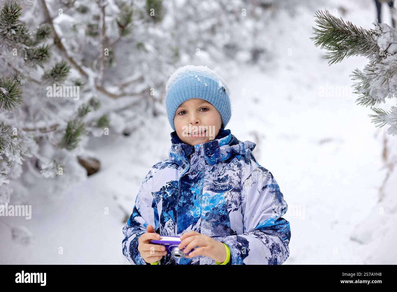 Sweet happy children, brothers, playing in deep snow in forest, frosted ...