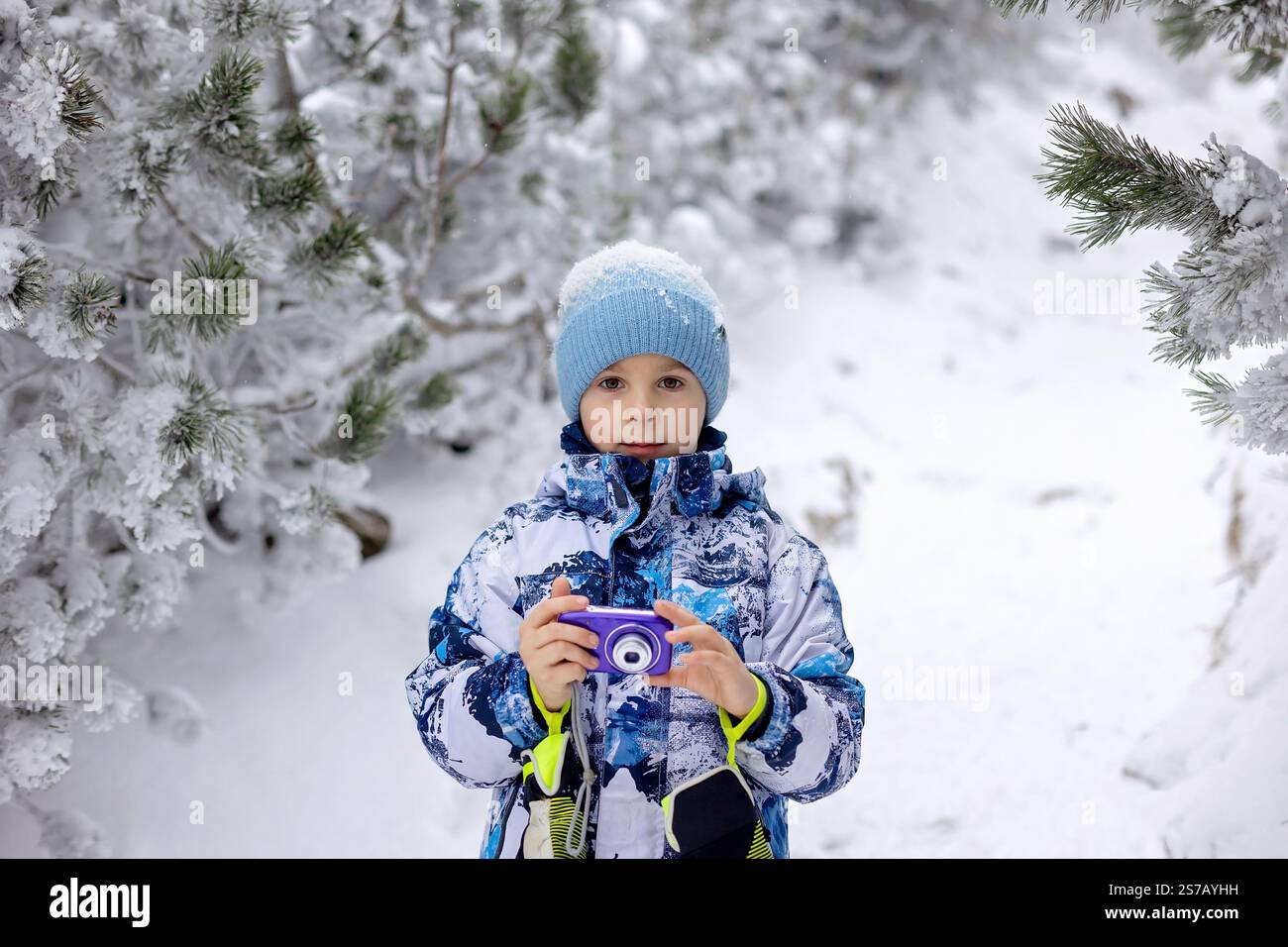 Sweet happy children, brothers, playing in deep snow in forest, frosted ...