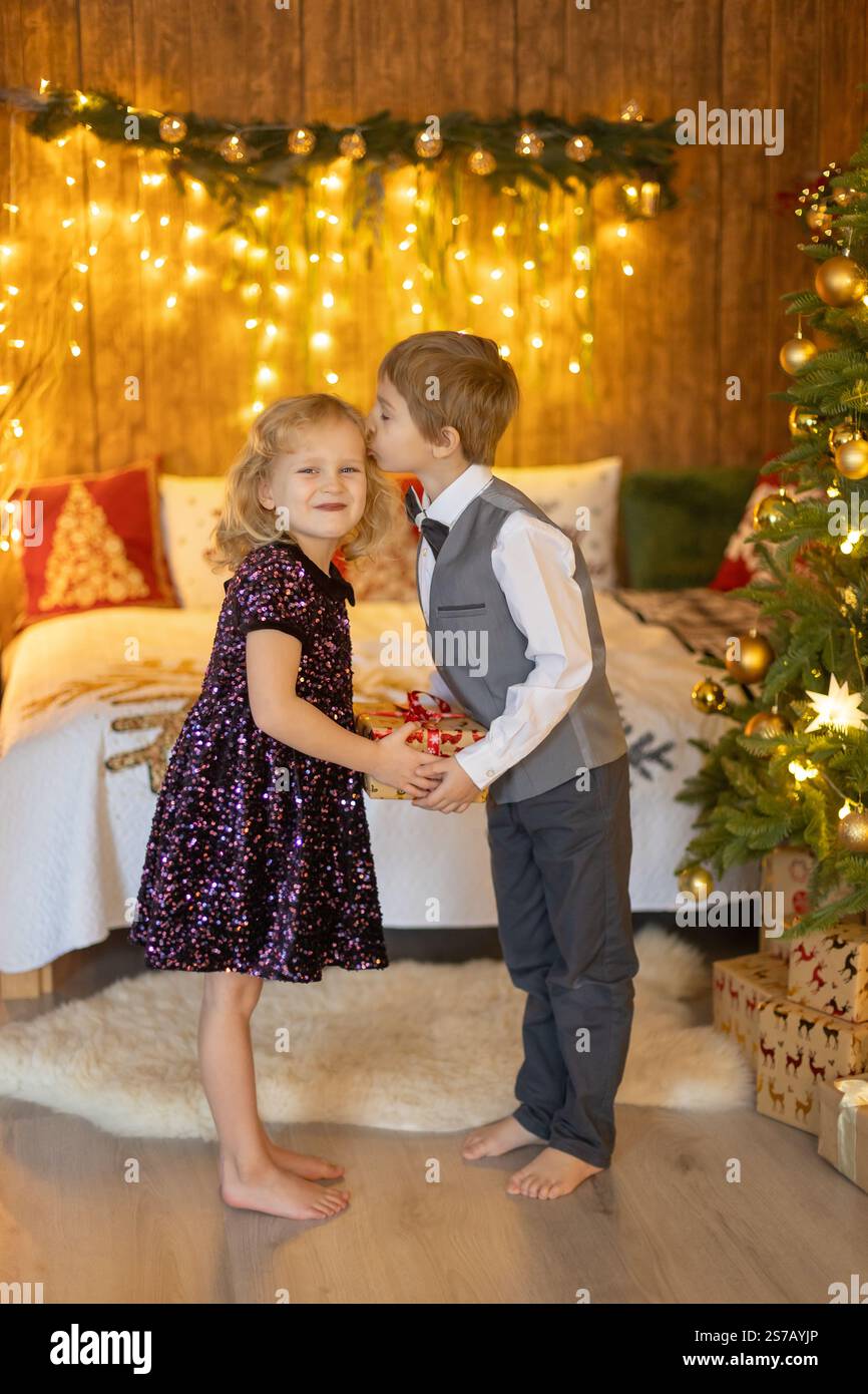 Sweet blond children, siblings, boy and girl, dressed smart casual in a ...
