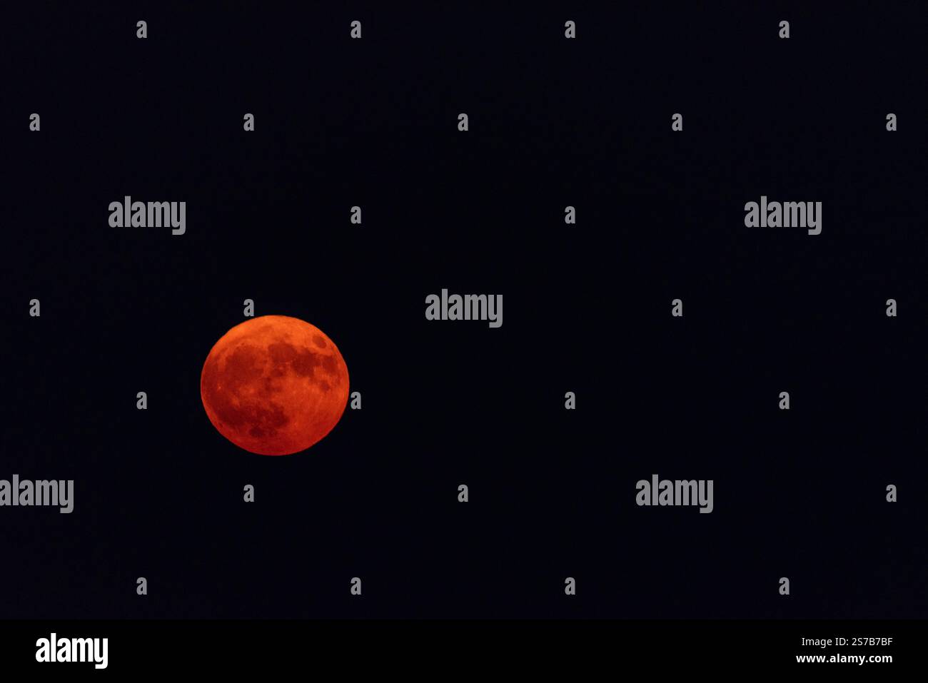 Orange-Tinted Full Moon in the Emptiness of a Black Sky Stock Photo - Alamy