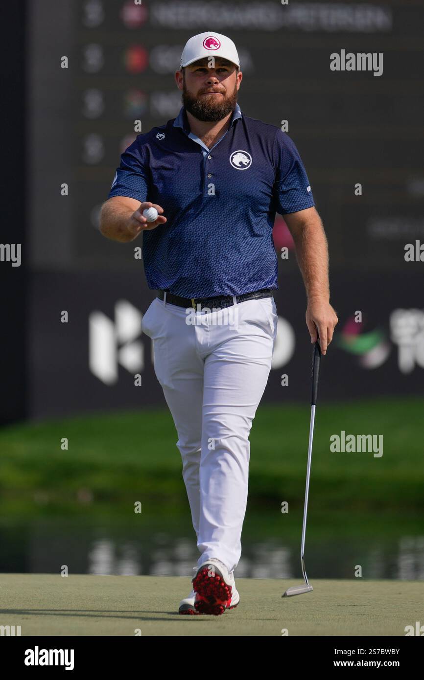 Tyrell Hatton of England walks with the ball on the 9th green during ...