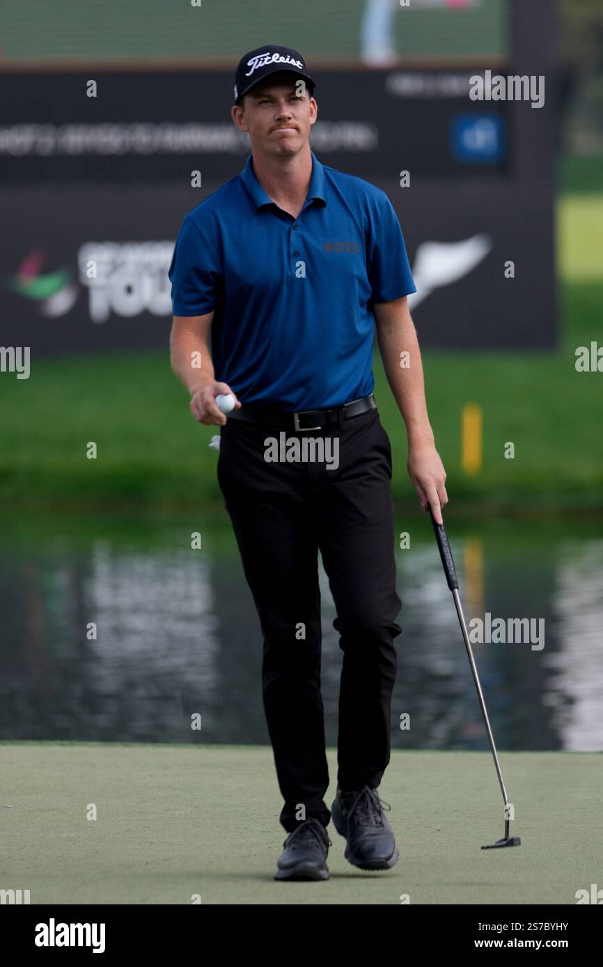 Daniel Hillier of New Zealand walks with the ball on the 9th green ...