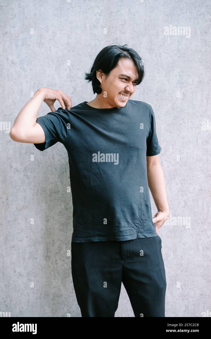 Man scratches his itchy back, expressing discomfort and irritation ...