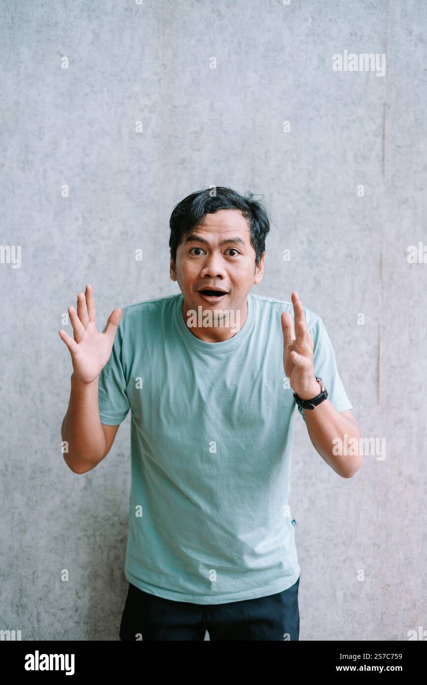 Surprised Asian man reacting to something he see Stock Photo - Alamy