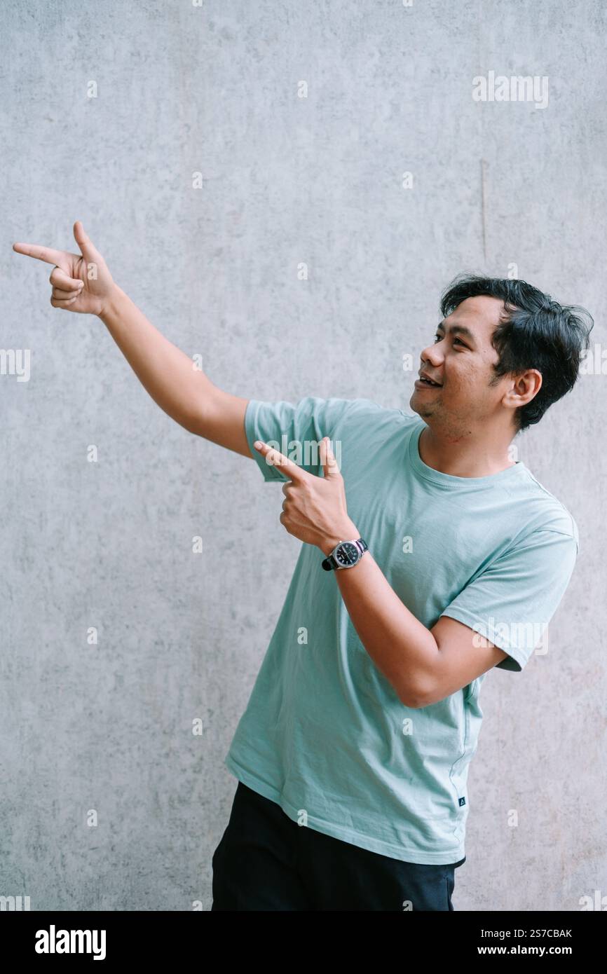 Man excitedly pointing upwards, showing direction with enthusiasm Stock ...