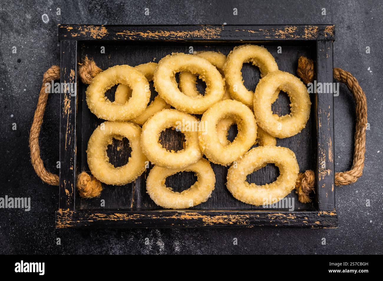 Raw squid rings with breading, uncooked calamari snack. black ...