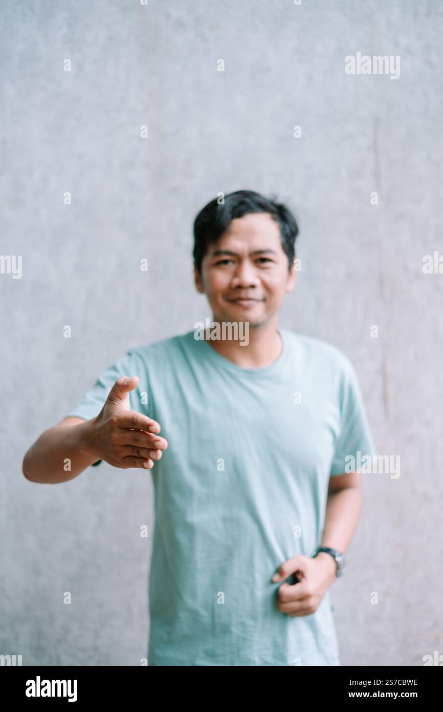 Man extending hand for a handshake, offering a greeting or agreement ...
