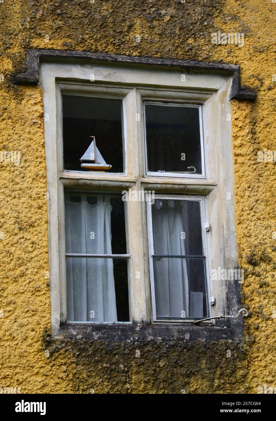Close up picture of a traditional wooden window of an old rural cottage ...