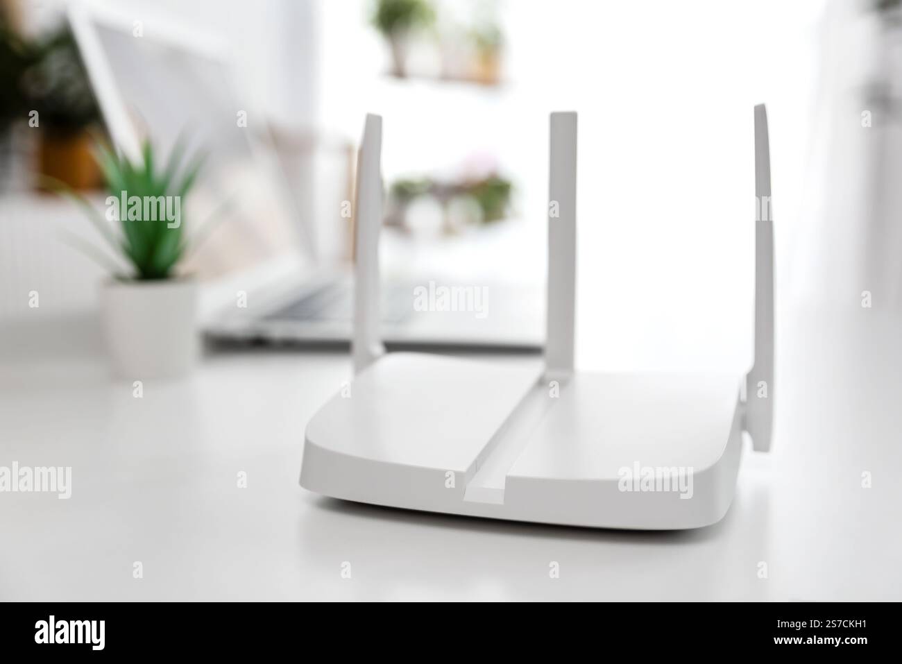 Modern wi-fi router on light table in living room Stock Photo - Alamy