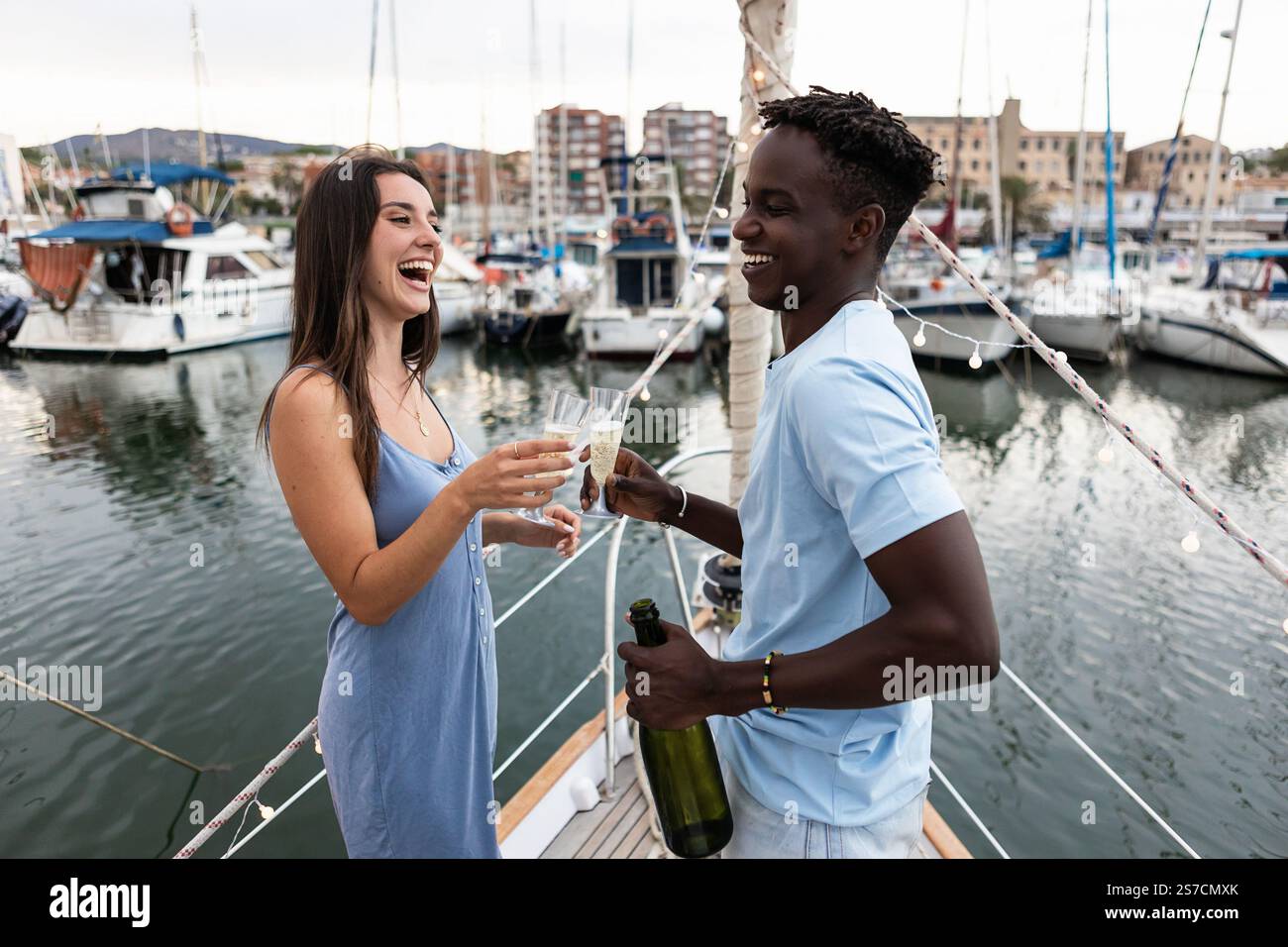 Biracial couple having fun while drinking champagne at party eve Stock ...