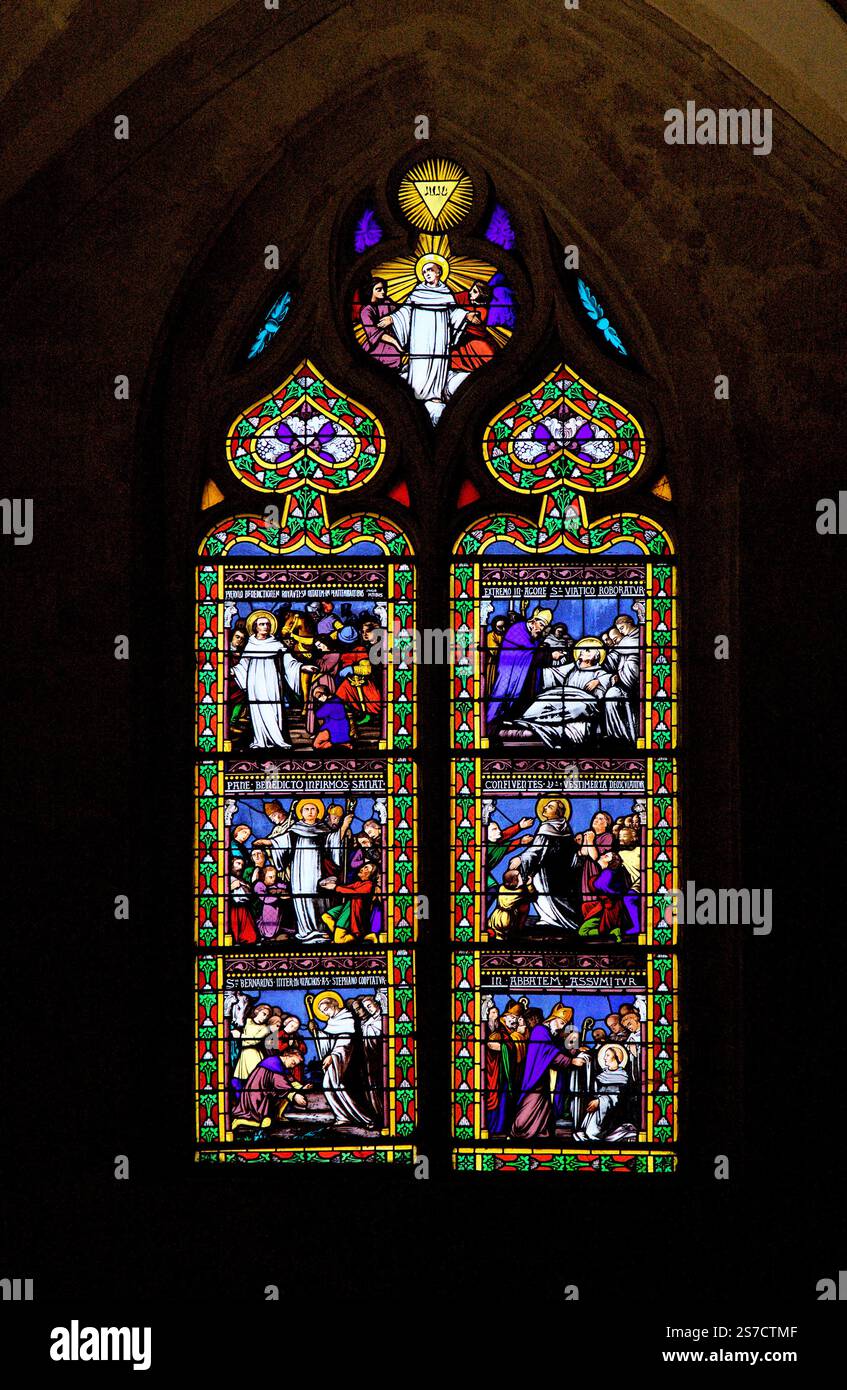 Vibrant stained glass window depicting a religious figure and a scene ...