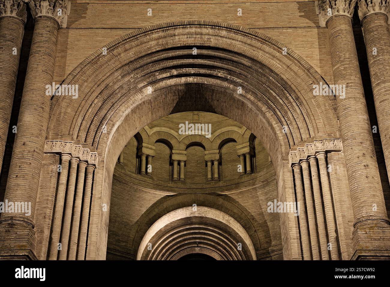 Historic Toulouse structure boasts intricate arches and columns, beautifully lit at night for a ...