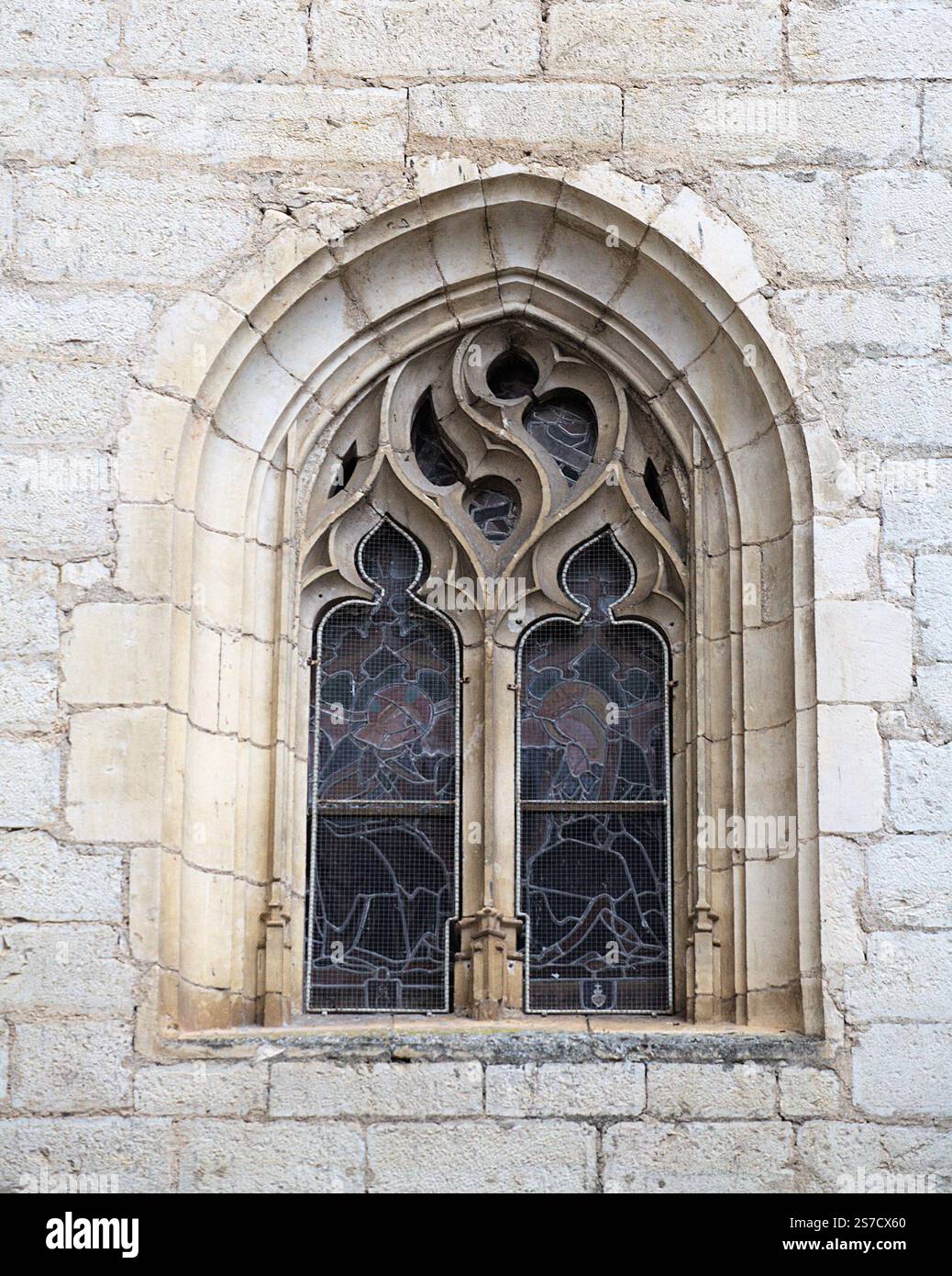 Stunning gothic window reveals intricate stonework and stained glass in Rocamadour's historic ...