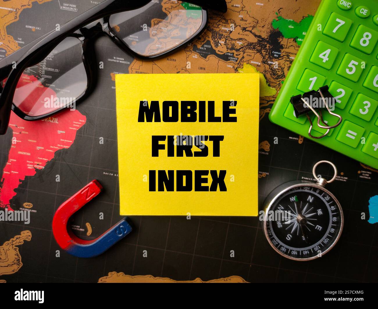 Top view compas,glasses and calculator with text MOBILE FIRST INDEX on ...
