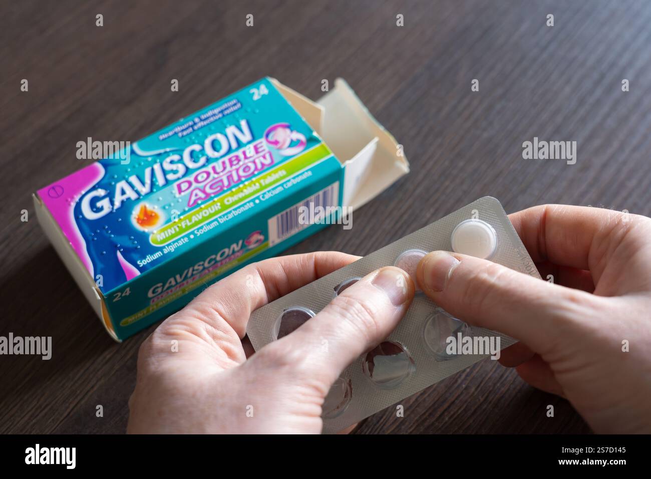 Middle aged man removing a tablet of Gaviscon Double Action – medicine ...