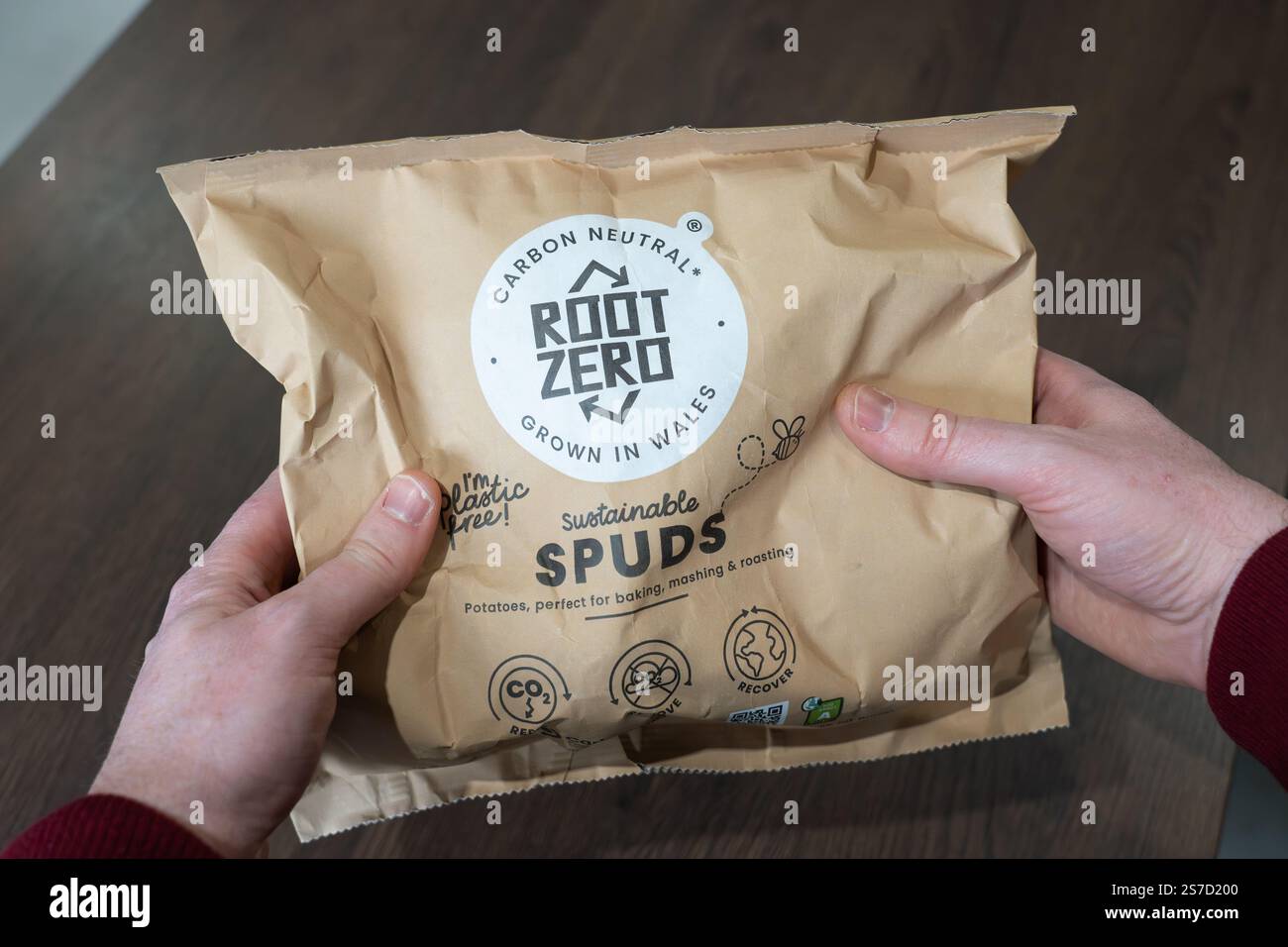 Middle aged man holding Root Zero sustainable spuds (potatoes), grown ...