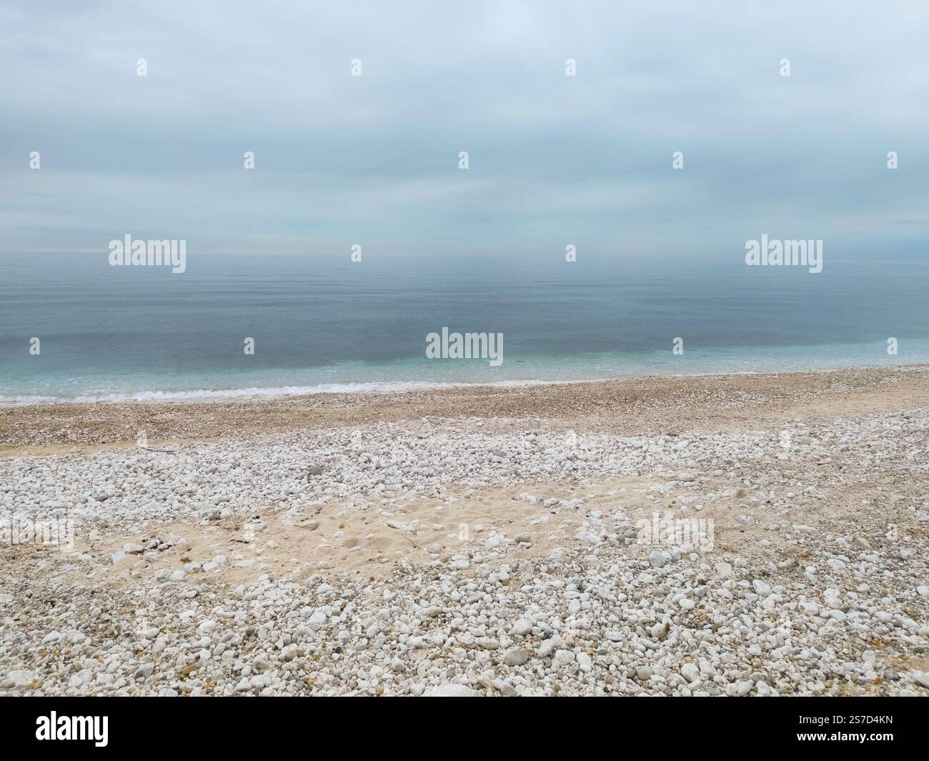 Quiet Coastal Beach Under a Cloudy Sky Stock Photo - Alamy