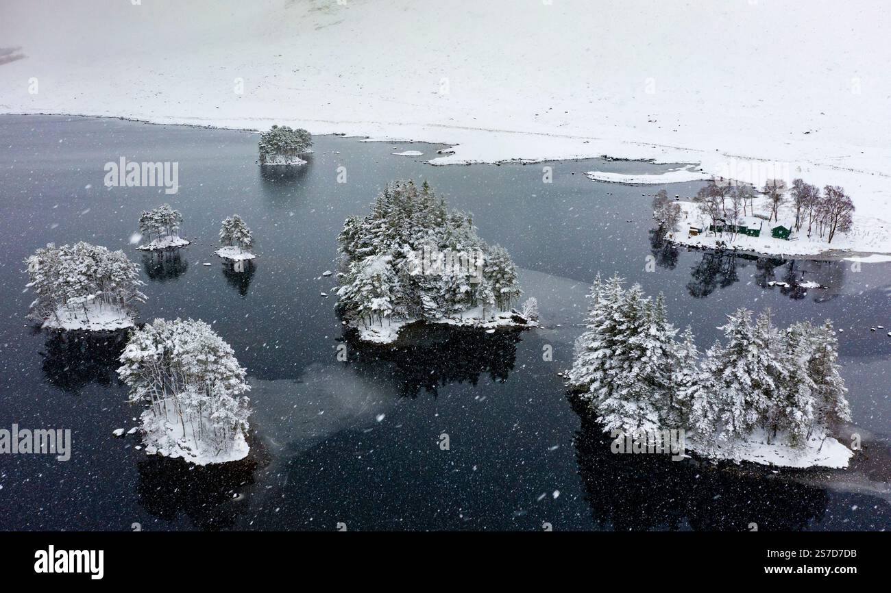 Aerial view from drone of winter snow covered landscape at Loch Ossian ...