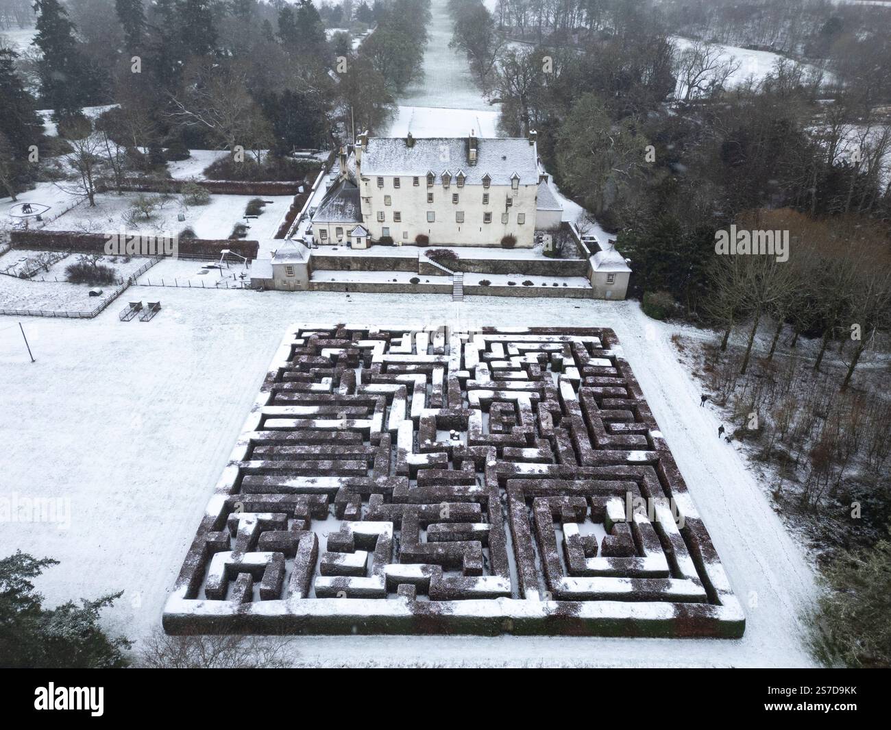 April view of maze at Traquair House in the snow in winter, Scotland ...