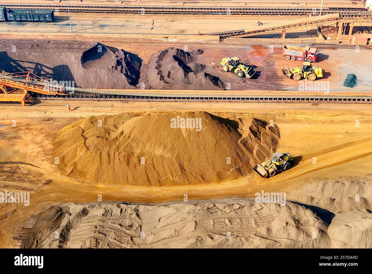 Loaders work at the dock for imported iron ore in Qingdao in east China ...