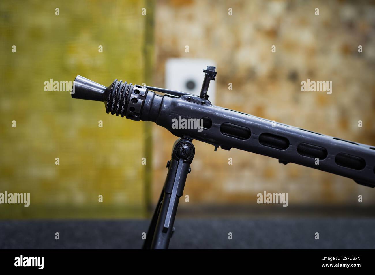 A close-up photo of a German machine gun barrel with a flash hider at a ...