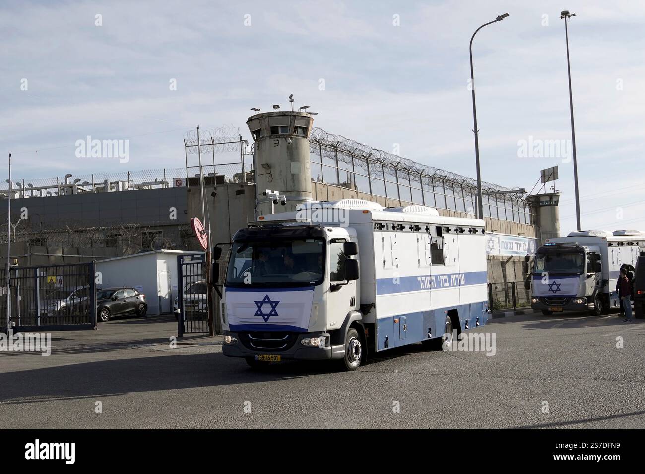 Israeli military buses are driven past the Ofer military prison near ...
