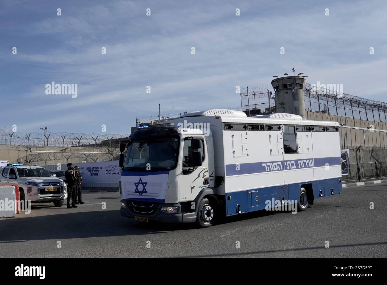 Israeli military buses are driven past the Ofer military prison near ...