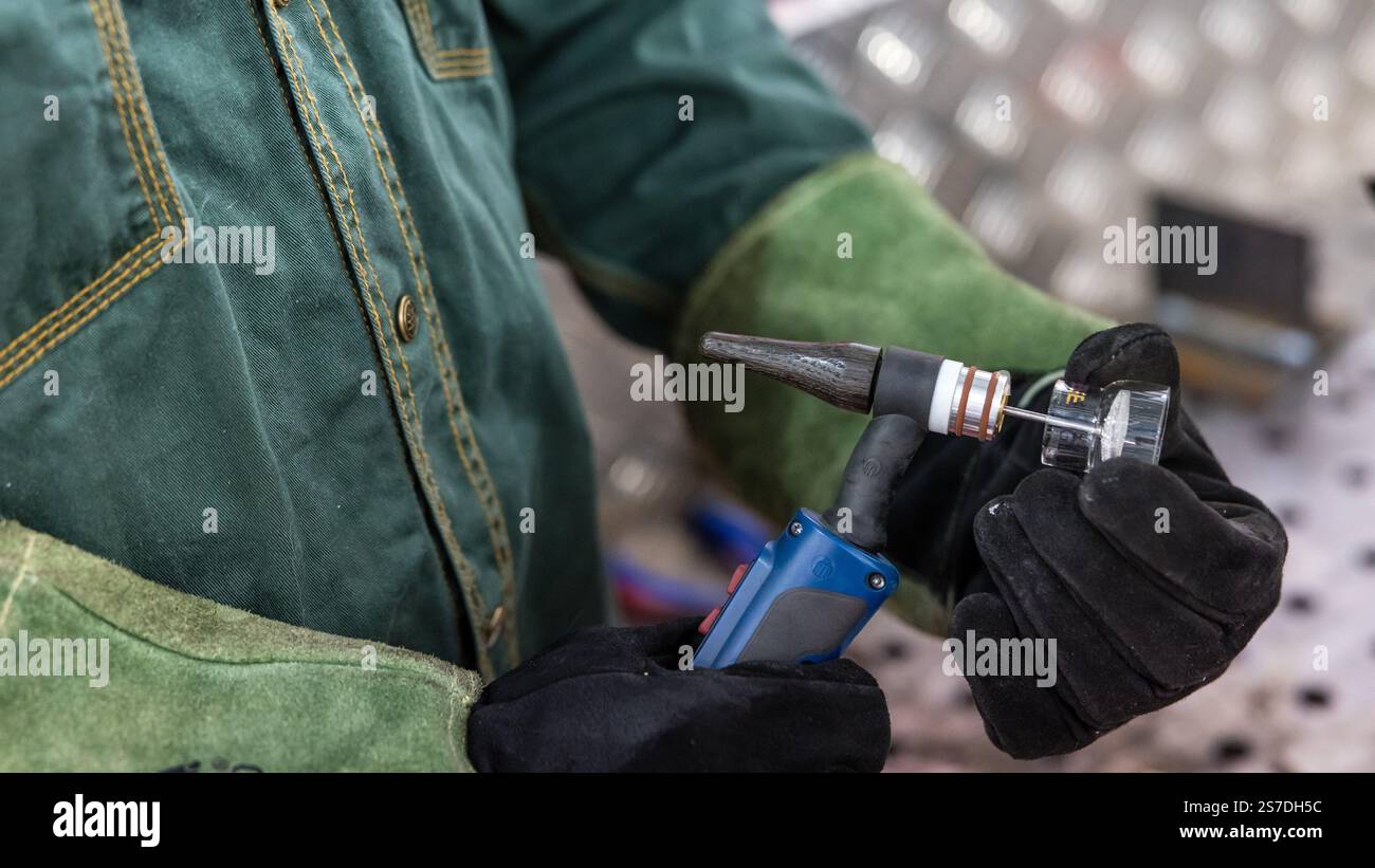 Cottbus, Germany. 19th Jan, 2025. A man is busy assembling a TIG torch ...