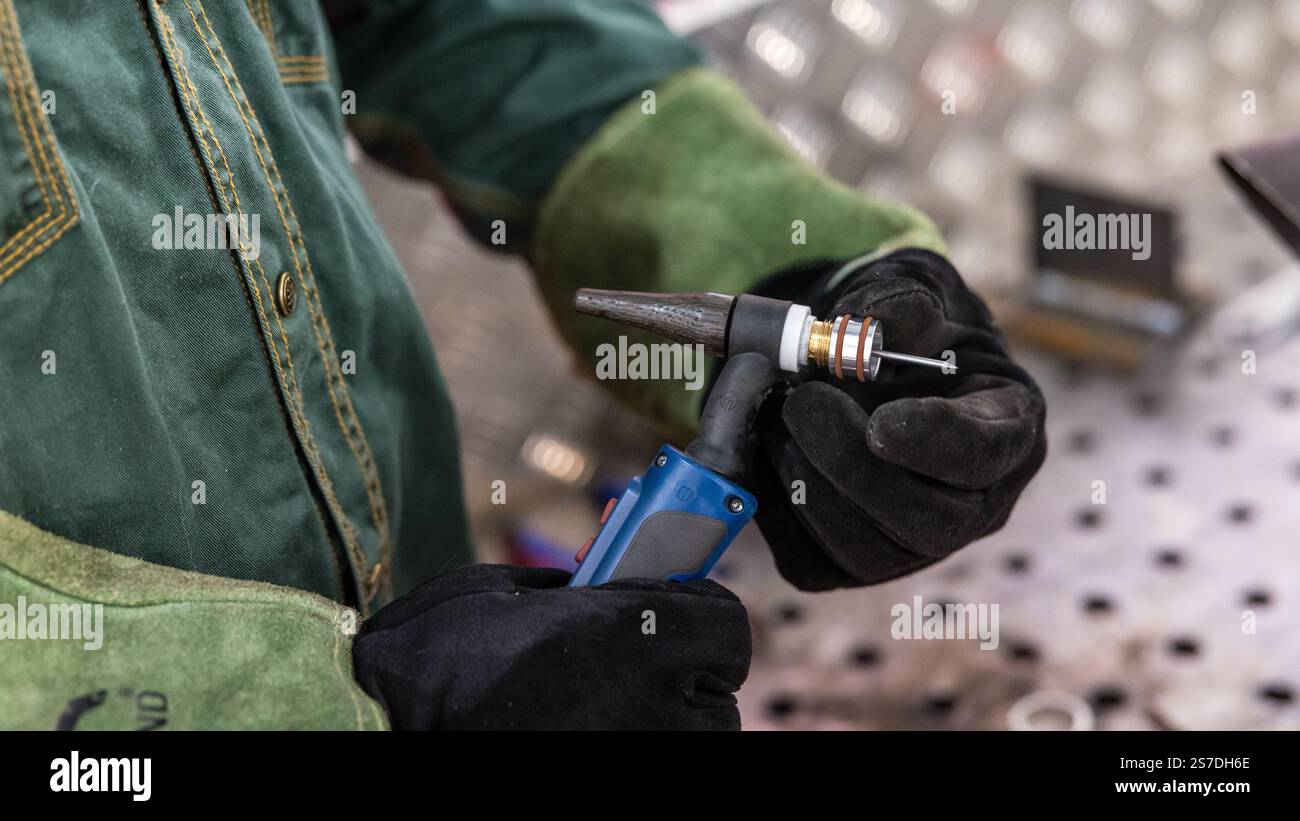 Cottbus, Germany. 19th Jan, 2025. A man is busy assembling a TIG torch ...