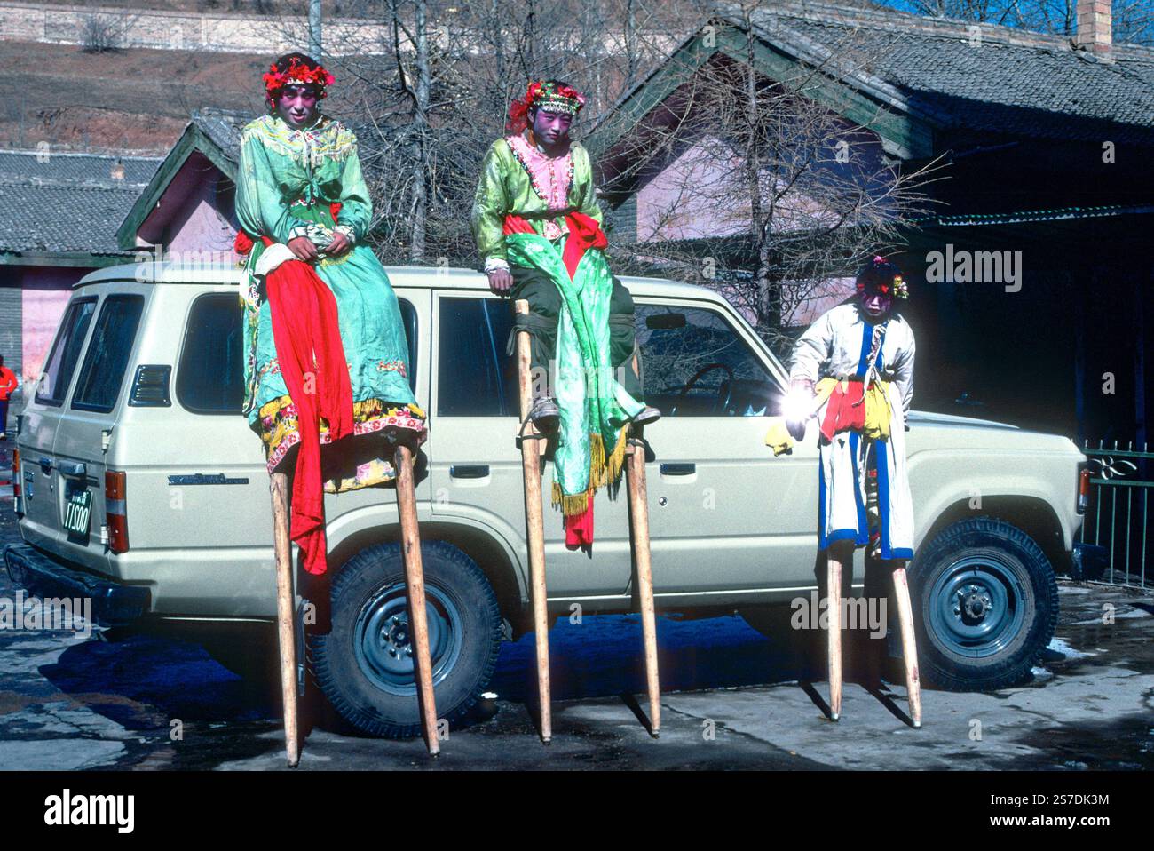 Chinese stilt performers dressed in costumes from Chinese mythology ...