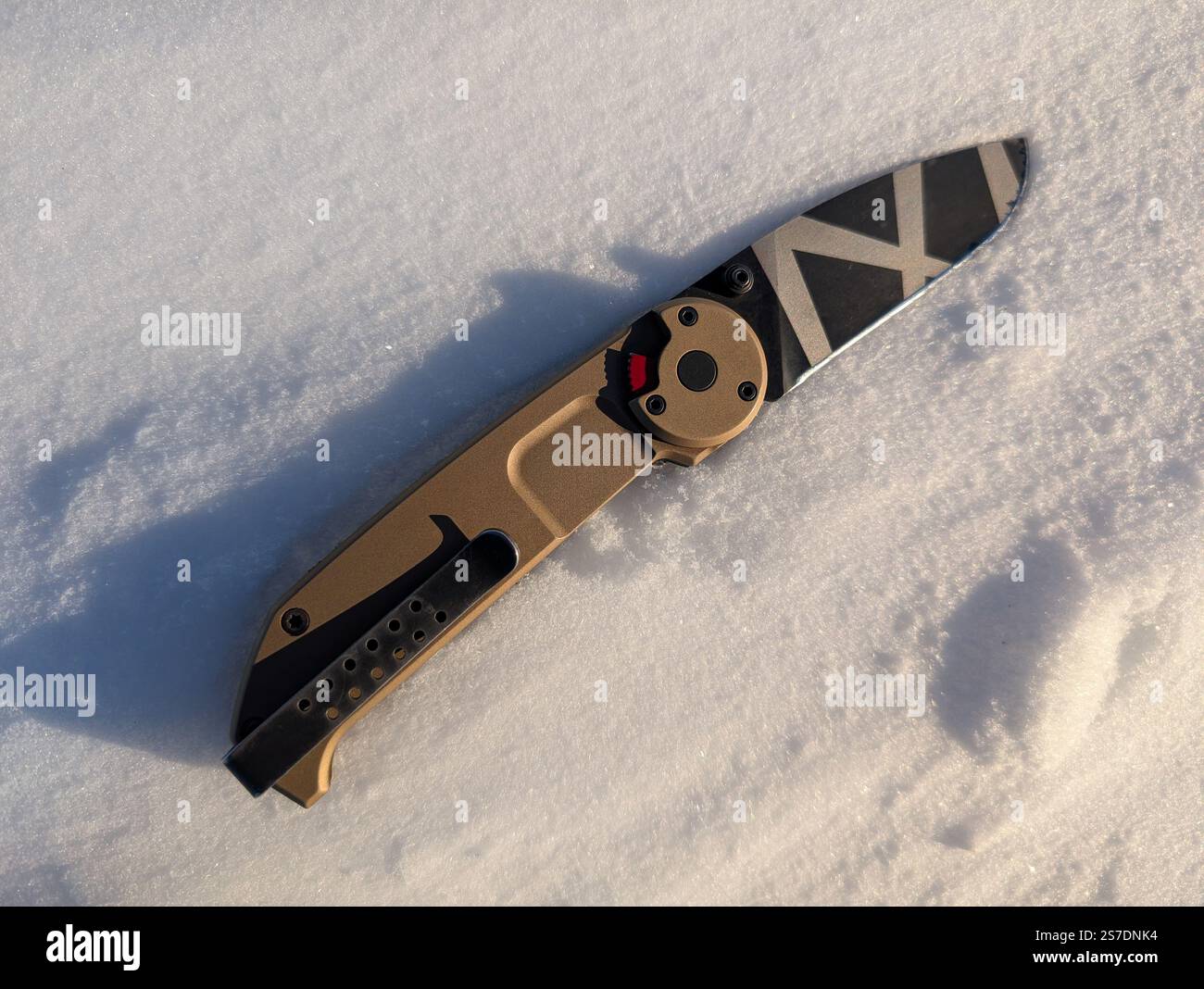 Folding tactical knife on white snow Stock Photo - Alamy
