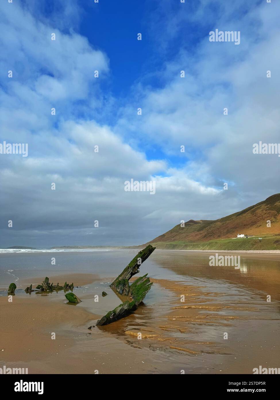 Rhossili beach with the wreck of the Helvetia and the old white cottage ...