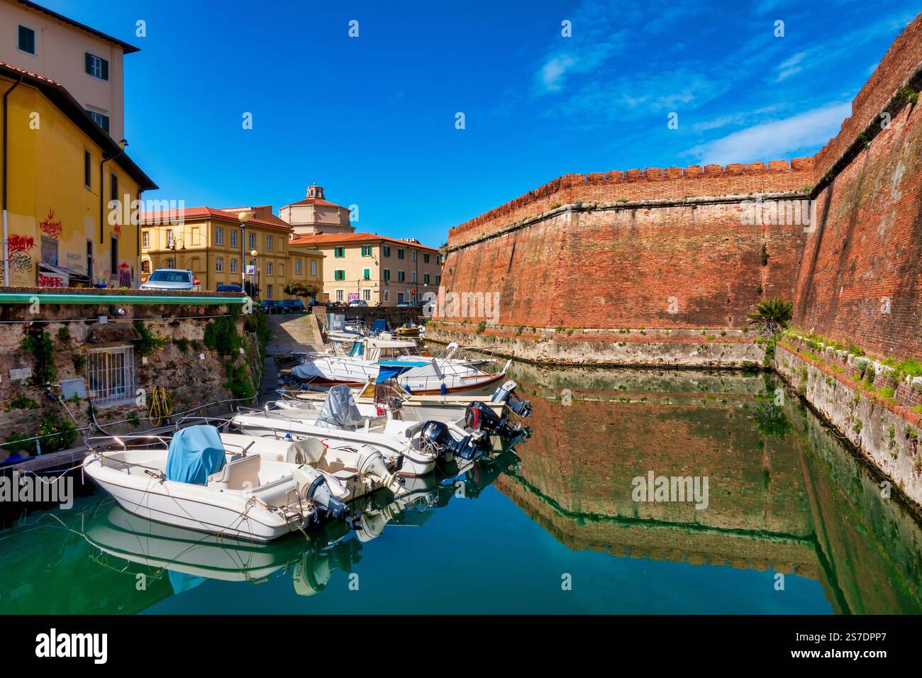 The canal surrounding Fortezza Nuova in Livorno, Italy, reflects the ...