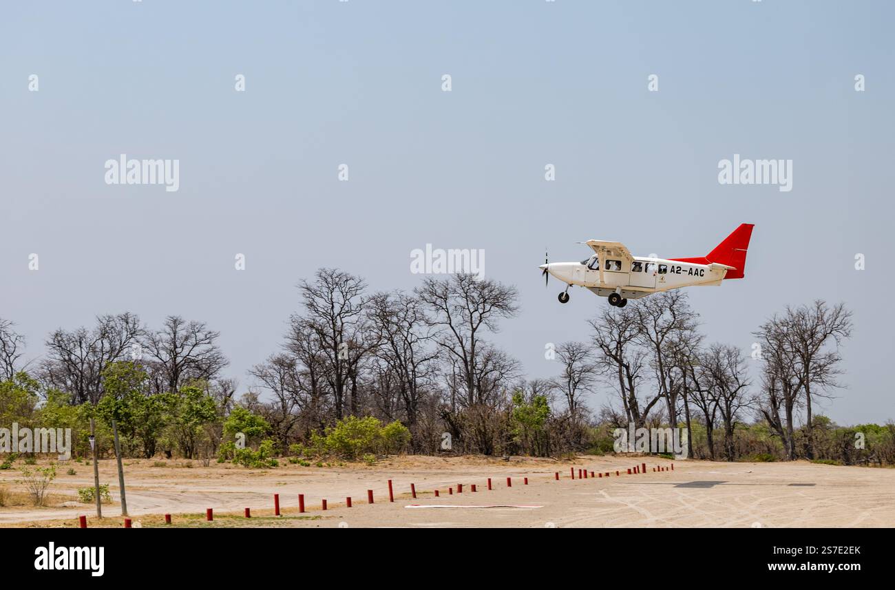 Safari Air tourist transport aeroplane taking off from Moremi airstrip ...