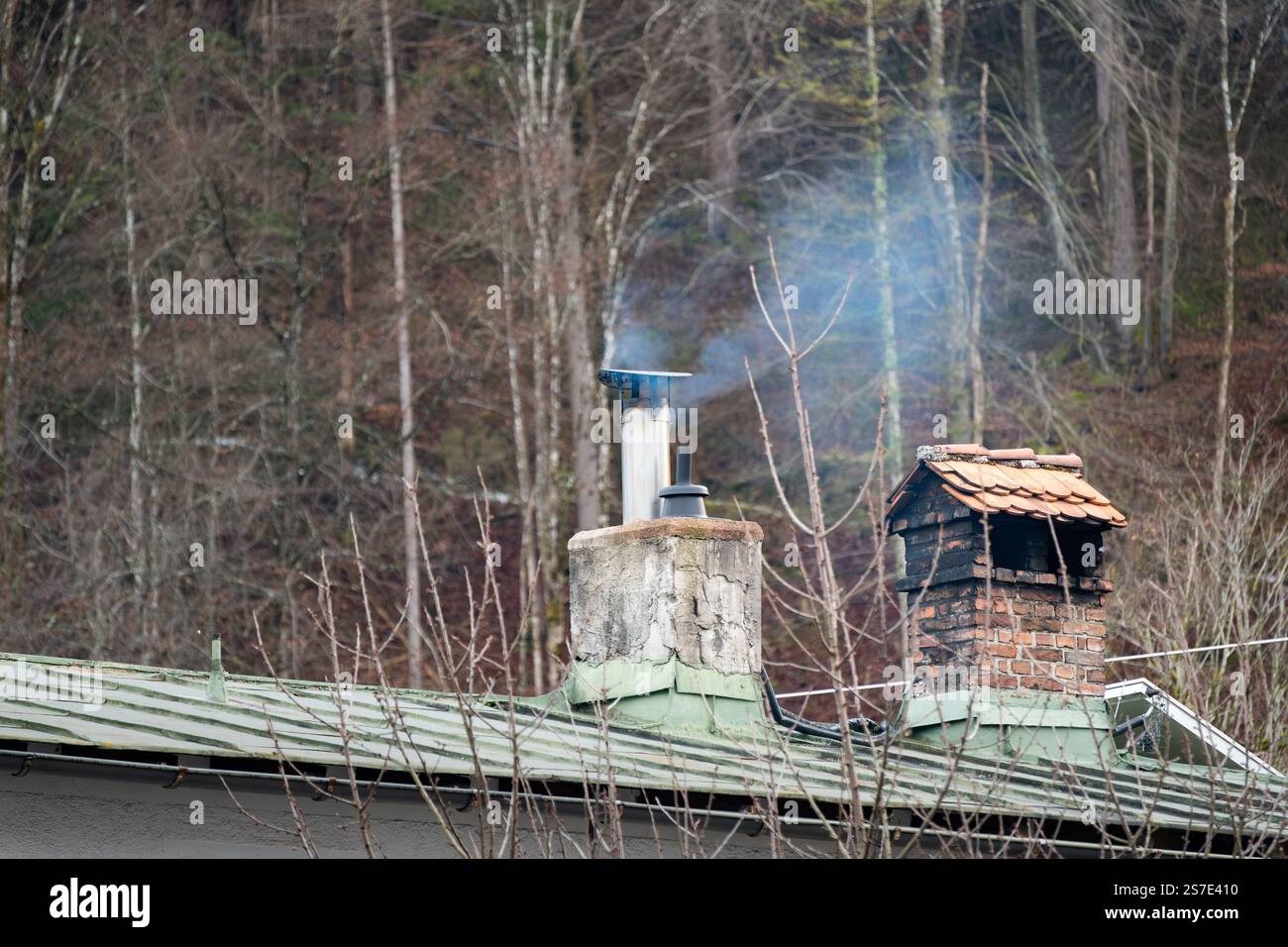 Chimney smoking of a detached house. Heating with wood, coal or wooden ...