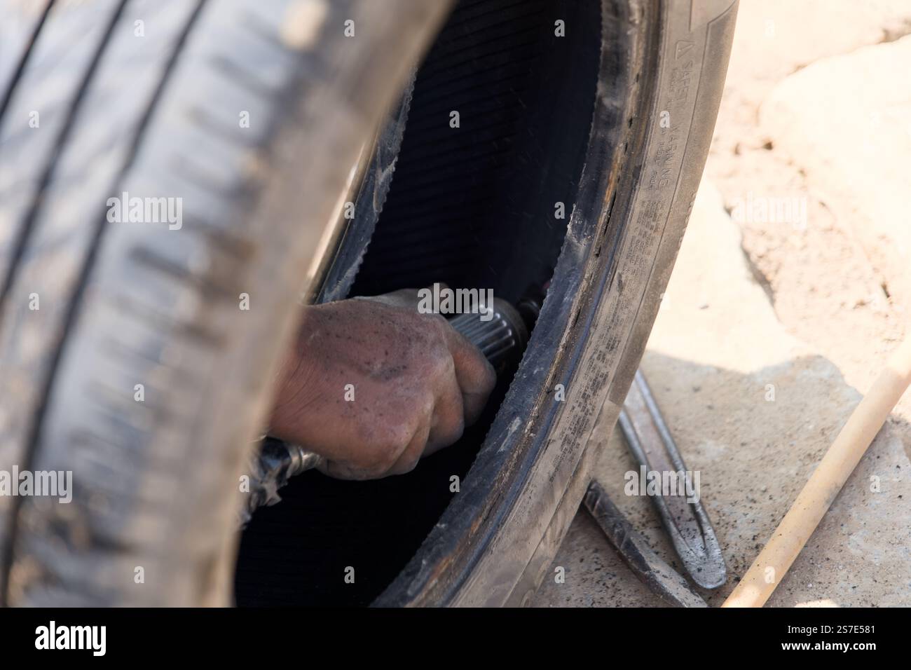 This image captures a detailed close-up of a person's hand working on ...