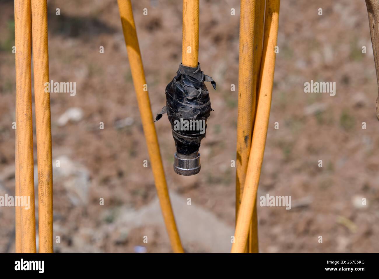 A close-up of a puncture air pump filler, showing the black tape ...