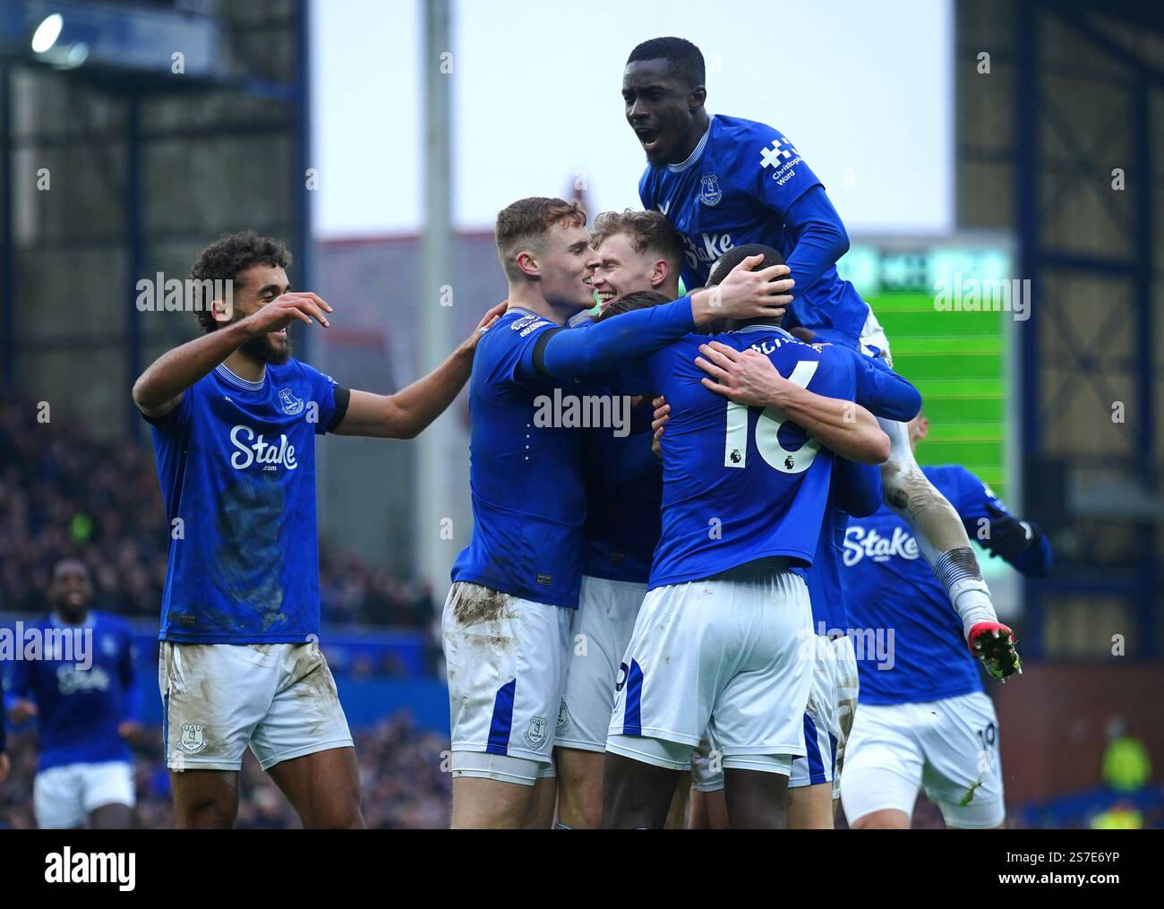 Everton players celebrate their side's third goal of the game, an own ...