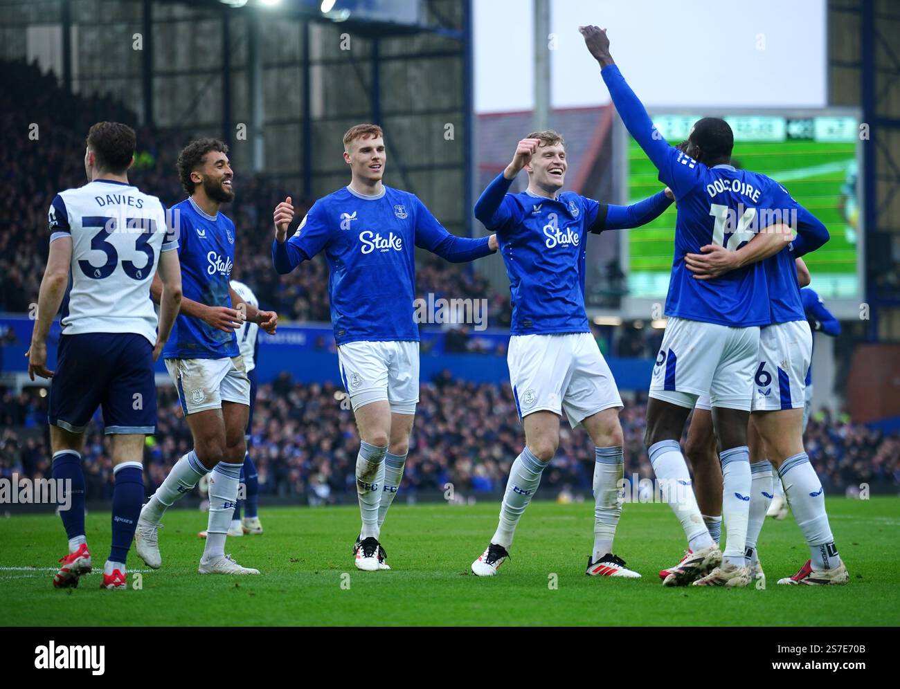Everton players celebrate their side's third goal of the game, an own ...