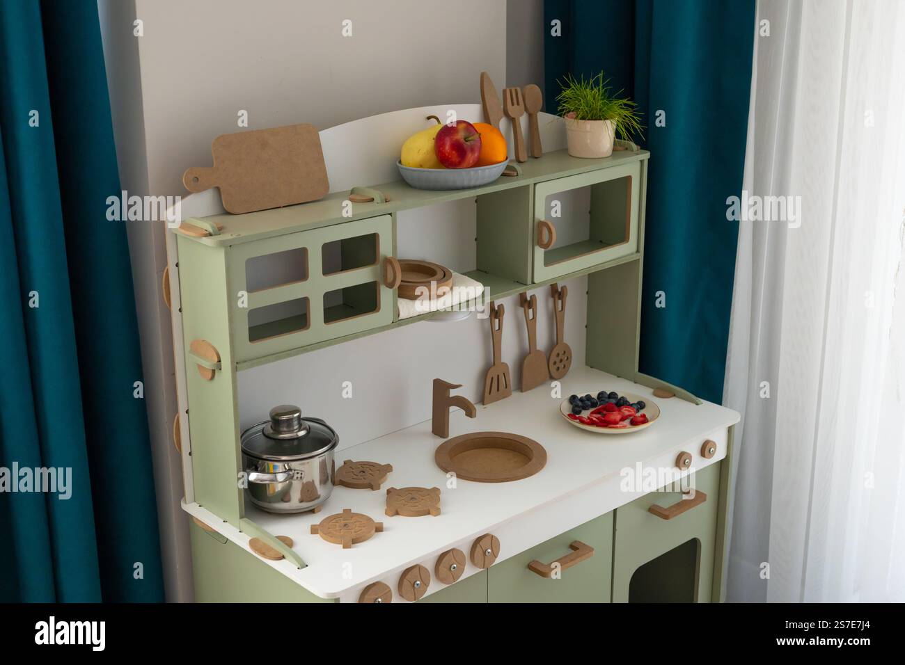 Children's cardboard kitchen set featuring utensils and play food ...