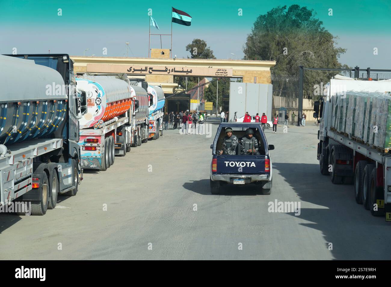 Trucks carrying humanitarian aids line up to cross the Rafah border ...