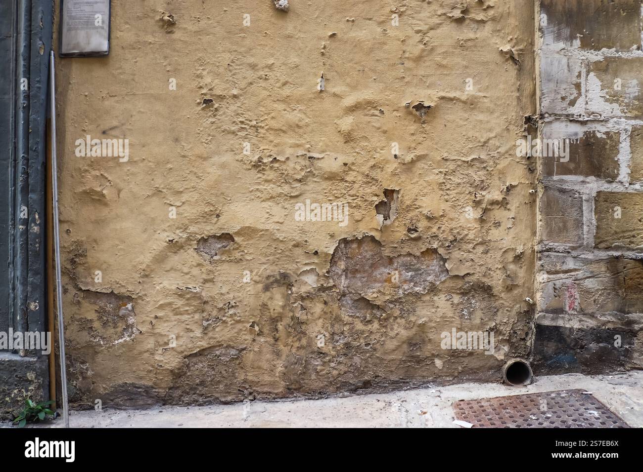 An ancient stone wall standing quietly in Malta's historic walkways ...