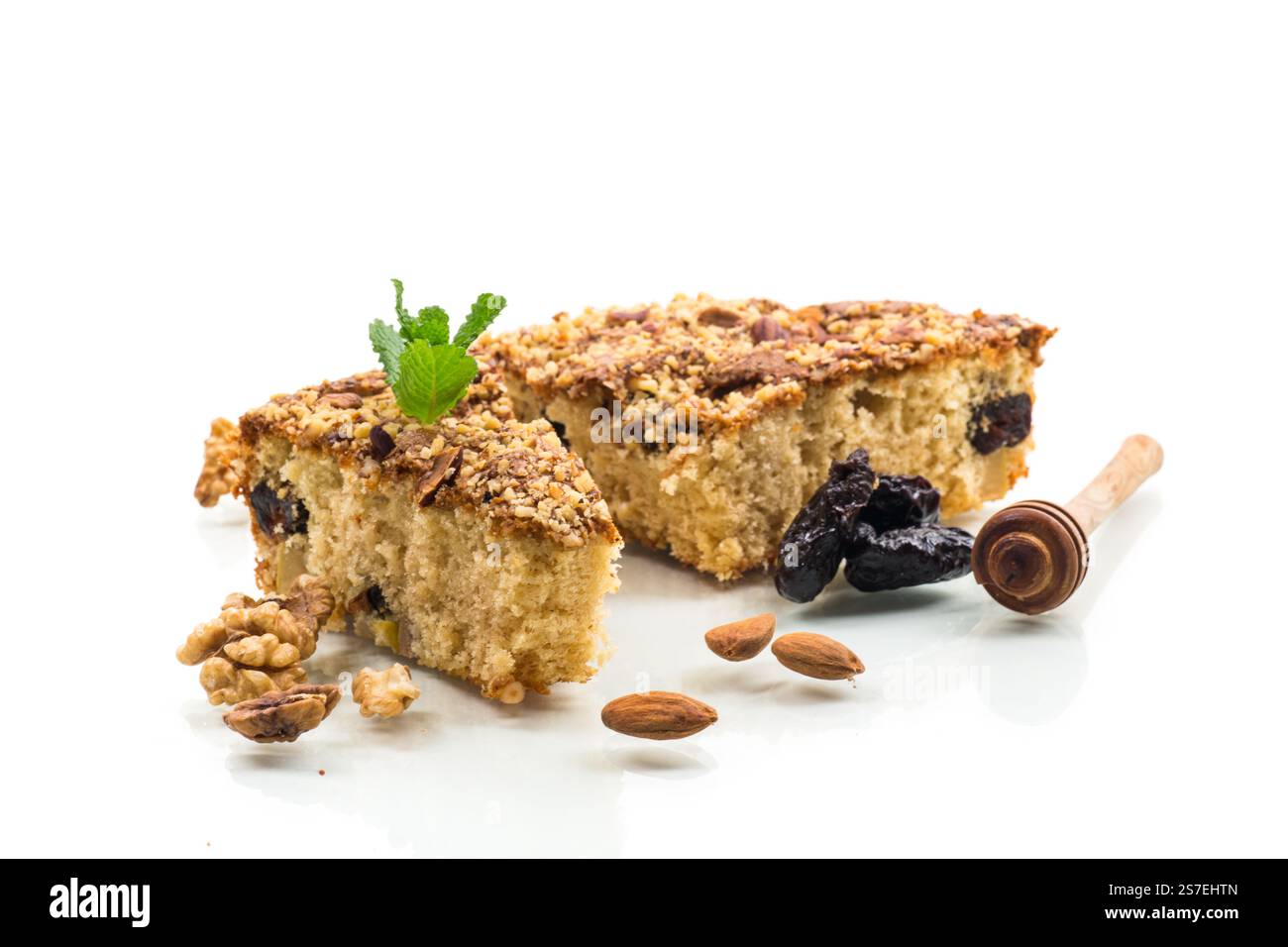 Ruddy sponge cake with prunes and nuts for tea, isolated on white ...