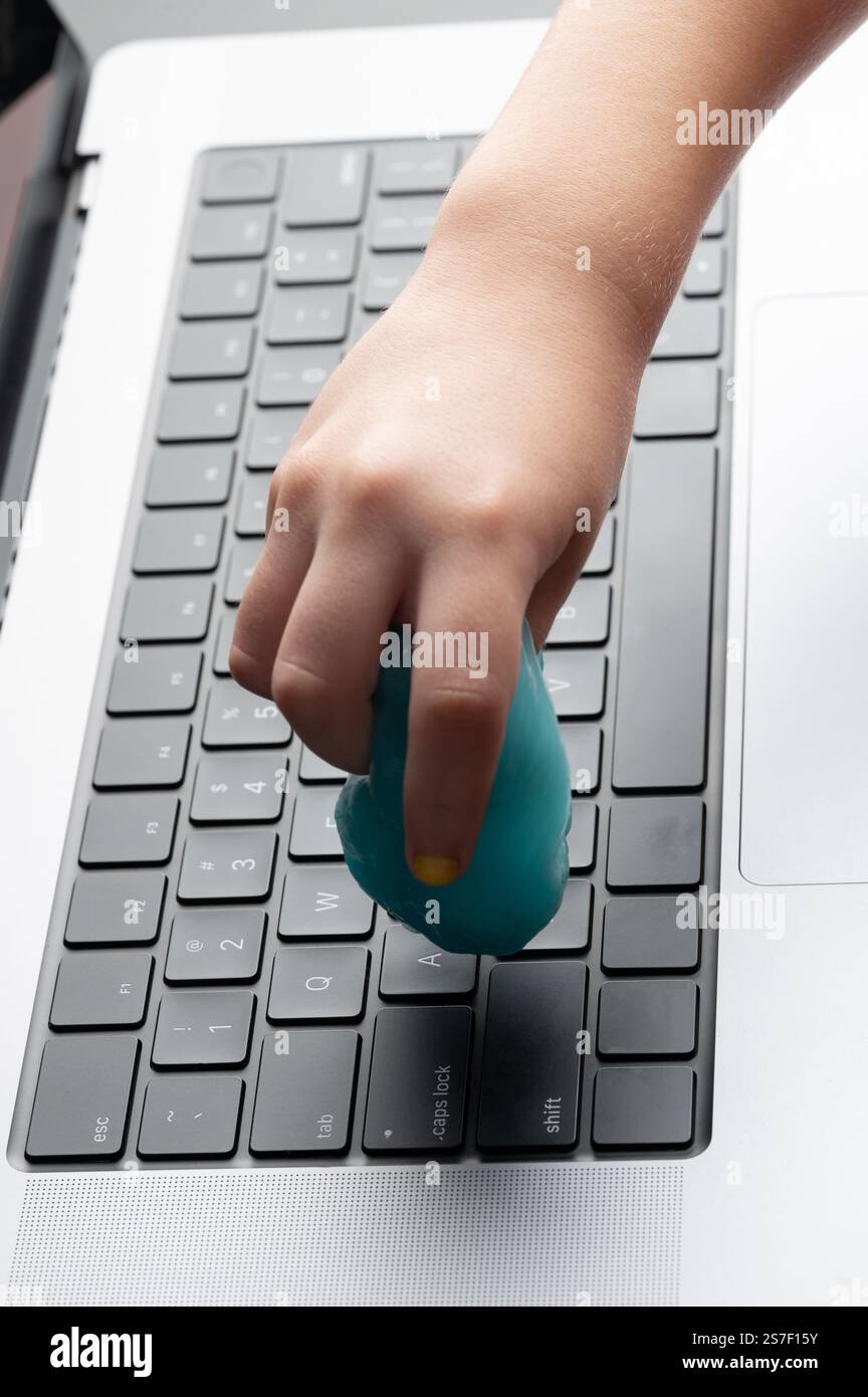 Cleaning keyboard with colorful sponge from small dust Stock Photo - Alamy