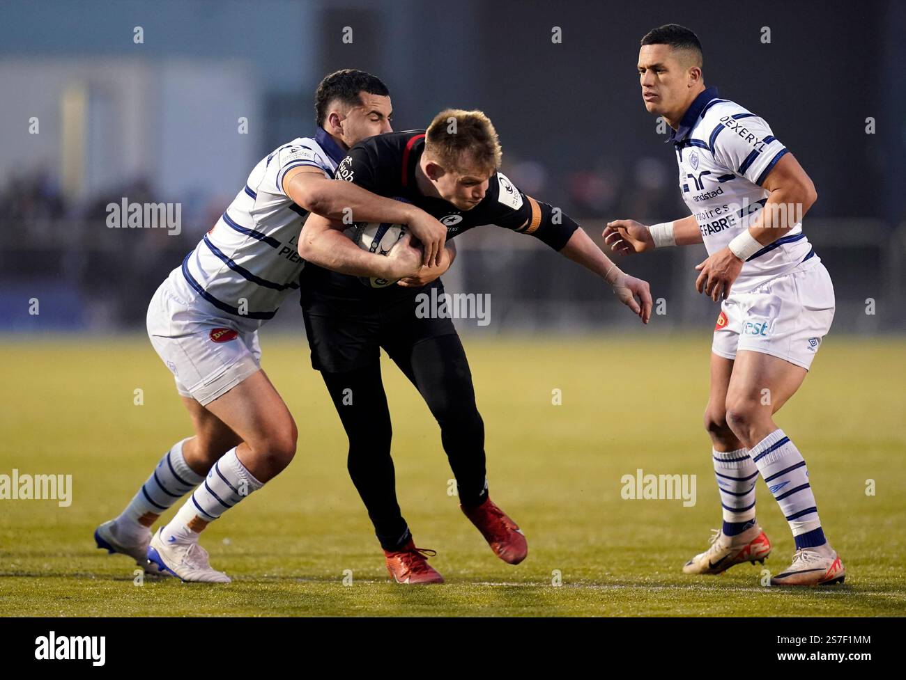 Saracens' Nick Tompkins (right) is tackled by Castres' Louis Le Brun ...
